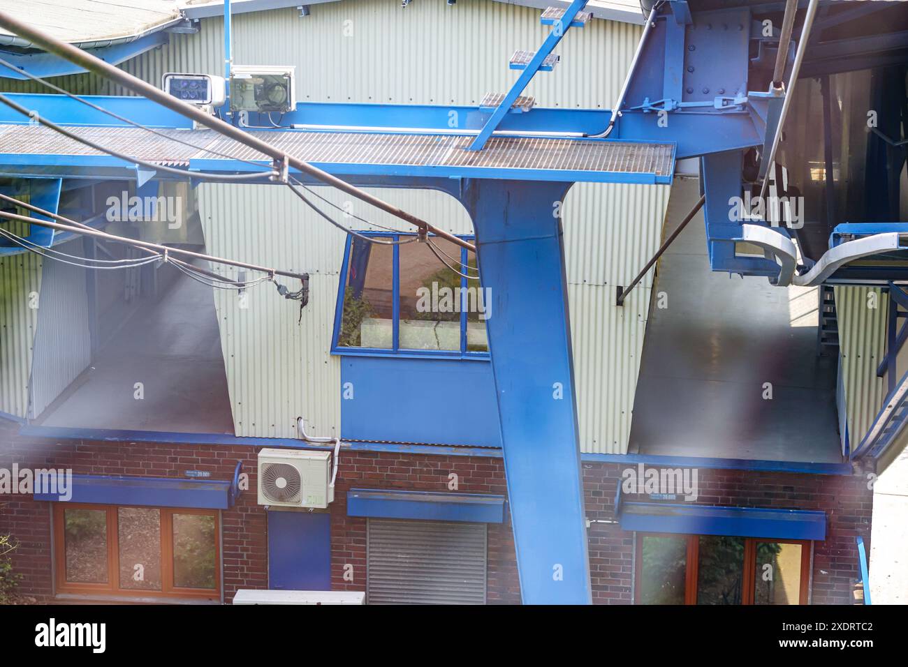 Empty central cable car station in Rheinpark public park, blue cables ...