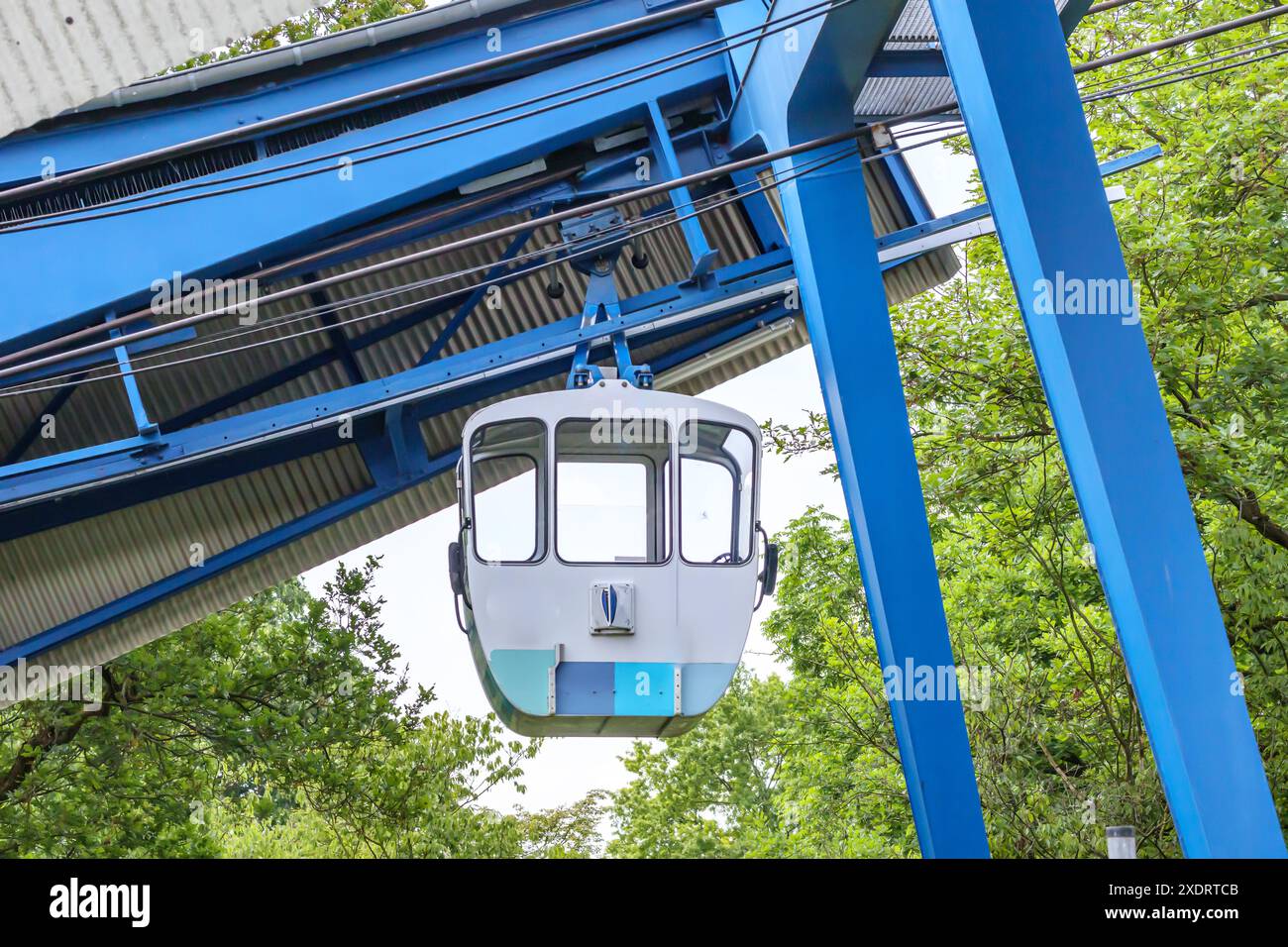 Empty cabin hanging from cable car on huge metal structure, leaving ...