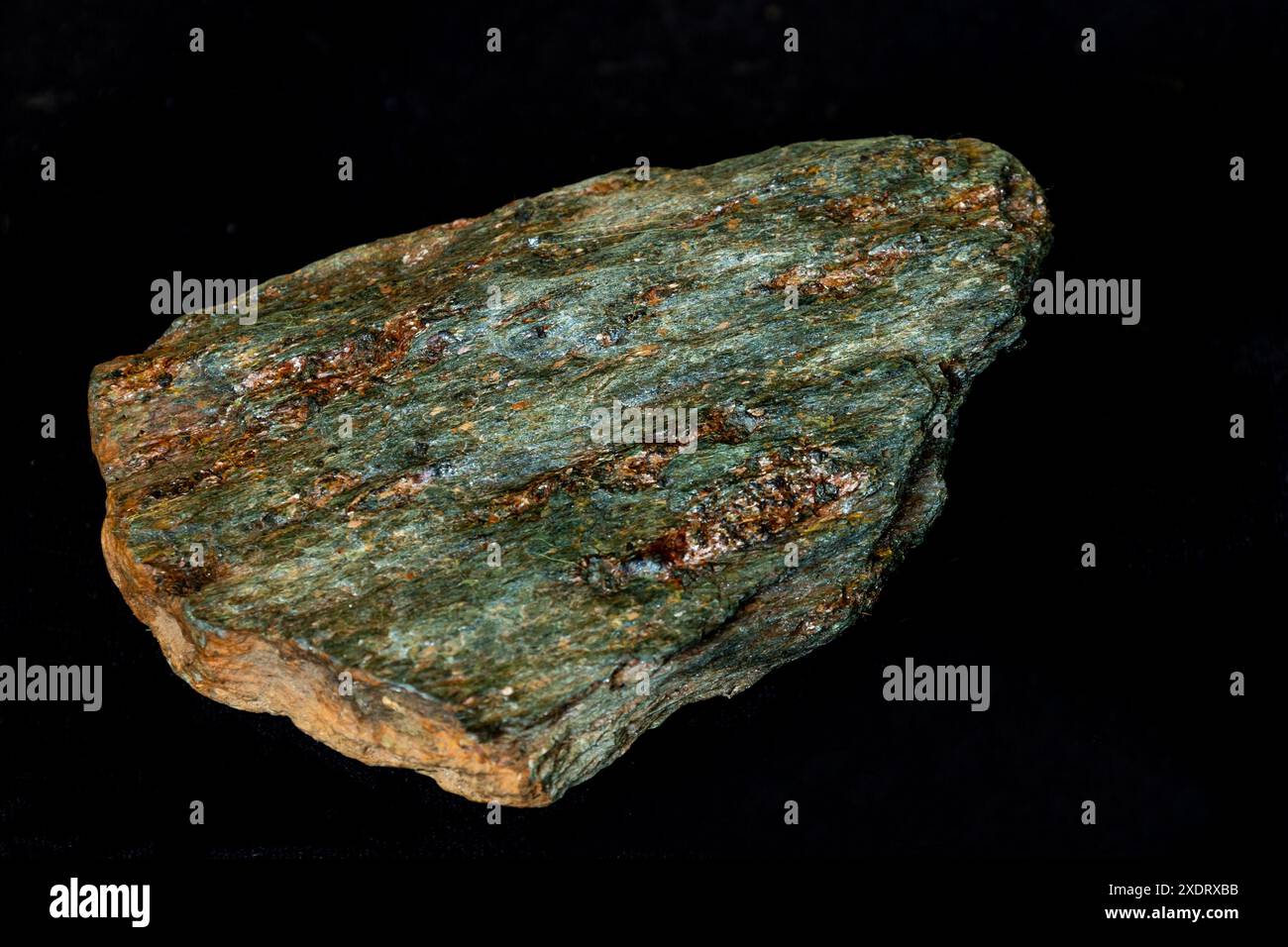 A sample of bright apple-green chlorite schist against a black ...