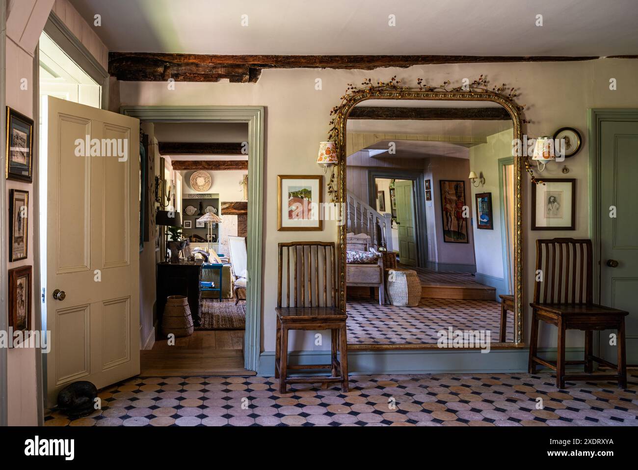Large gilt framed mirror inoriginal terracotta tiled hallway of ...