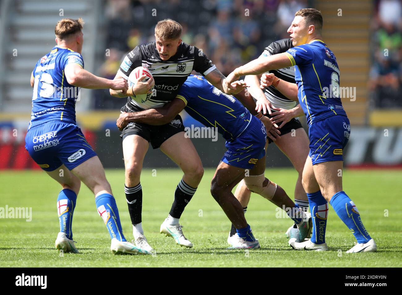 Hull FC's Liam Sutcliffe is challenged by Warrington Wolves' Matty ...