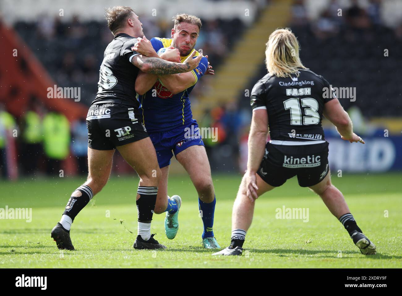 Warrington Wolves' James Harrison is tackled by Hull FC's Denive ...