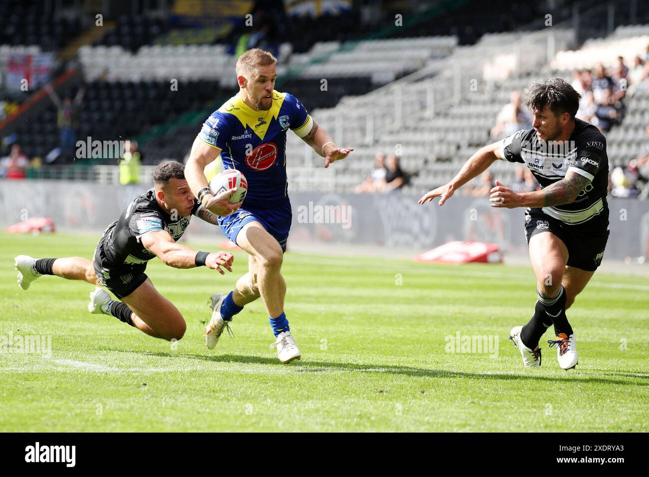 Warrington Wolves' Matt Dufty runs with the ball whilst under pressure ...