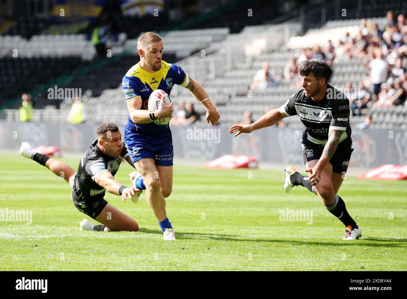 Warrington Wolves' Matt Dufty runs with the ball whilst under pressure ...