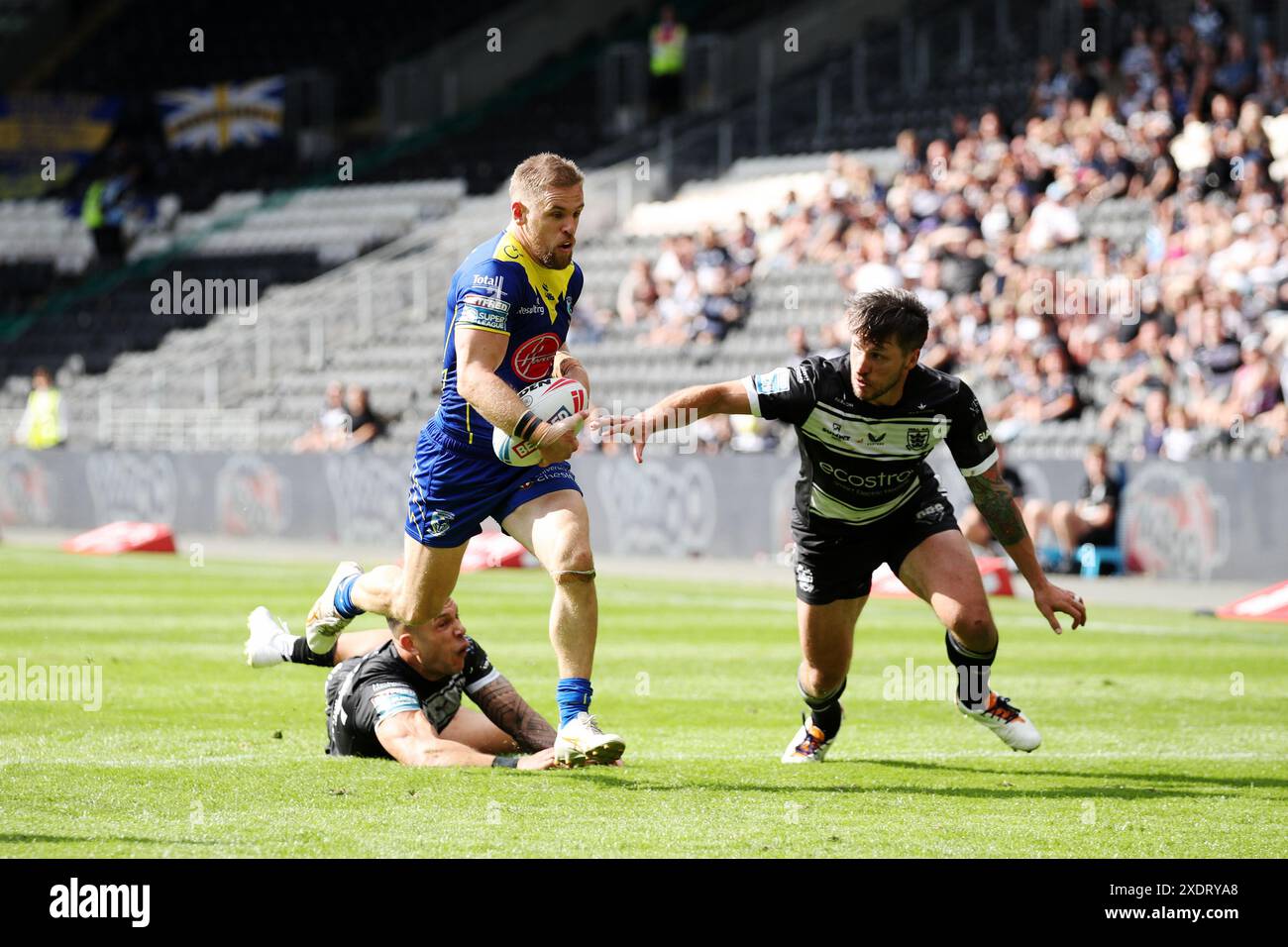 Warrington Wolves' Matt Dufty runs with the ball whilst under pressure ...