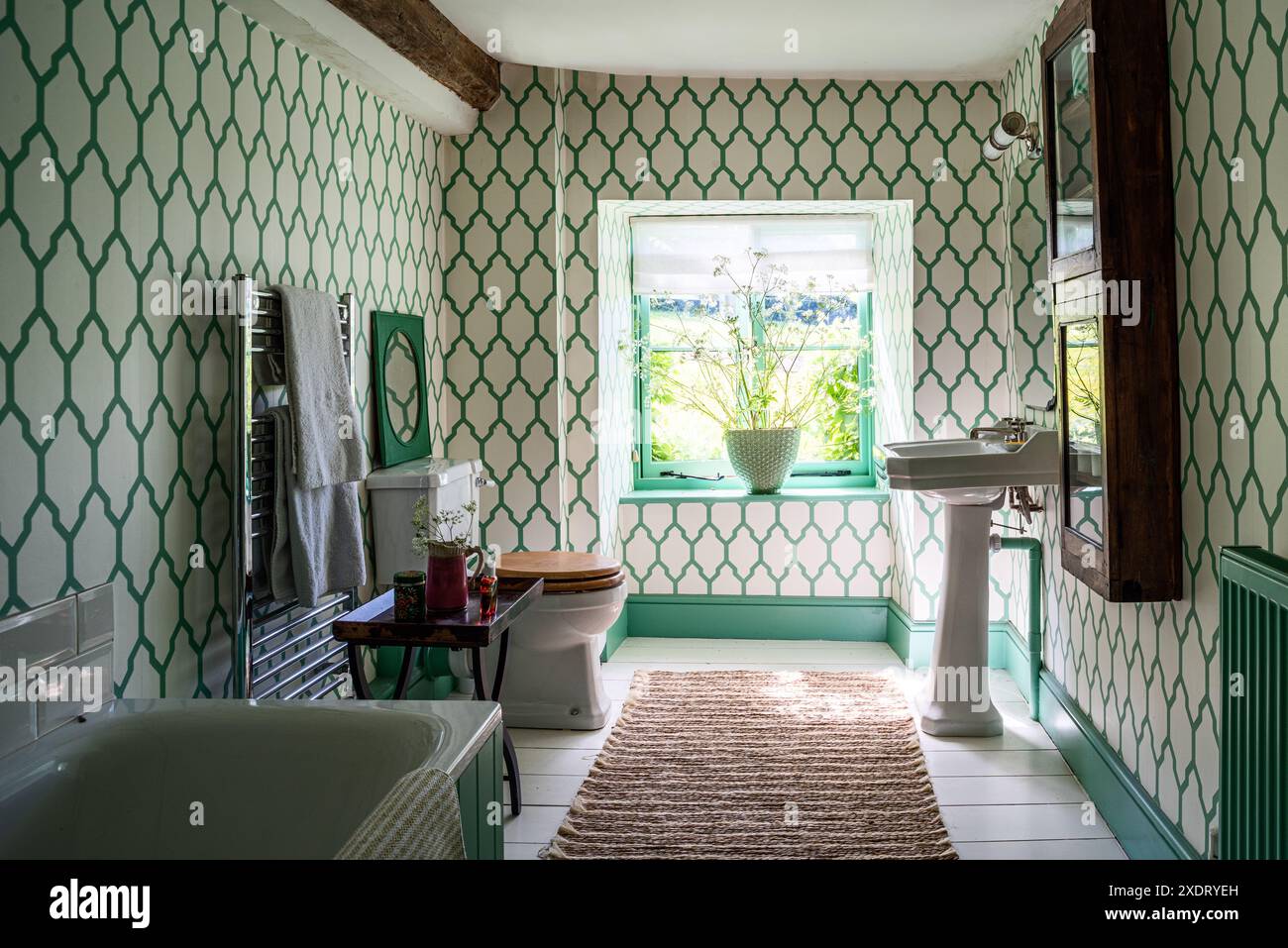 'Tessella' wallpaper with rush mat and backlit plant in bathroom window ...