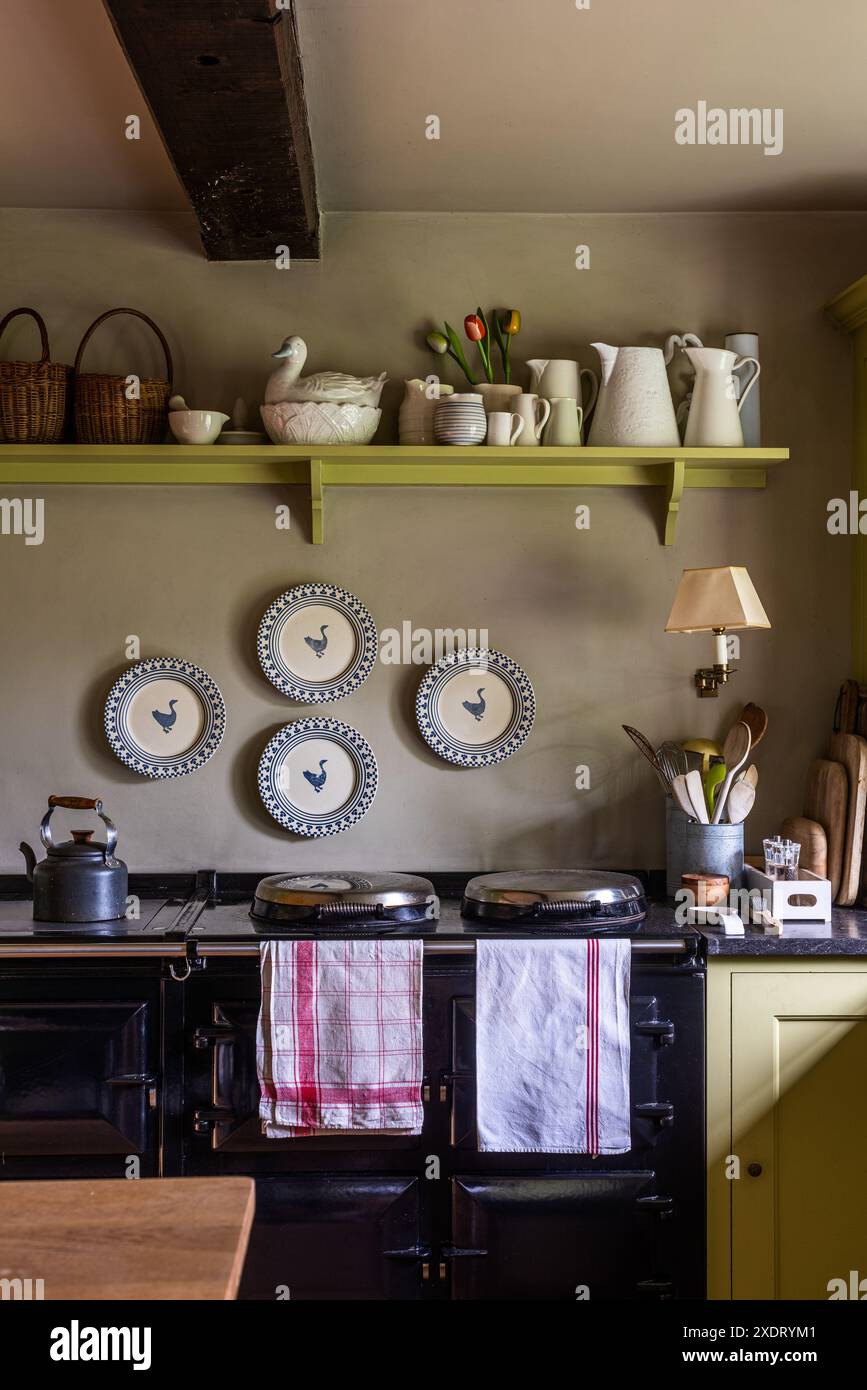Decorative plates above aga with shelf painted 'Churlish green' in ...
