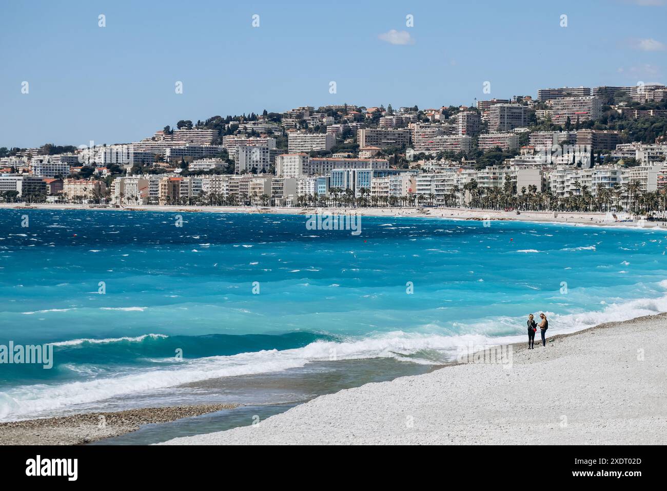Nice, France - 21 April 2024: People walking on the beach in Nice in ...