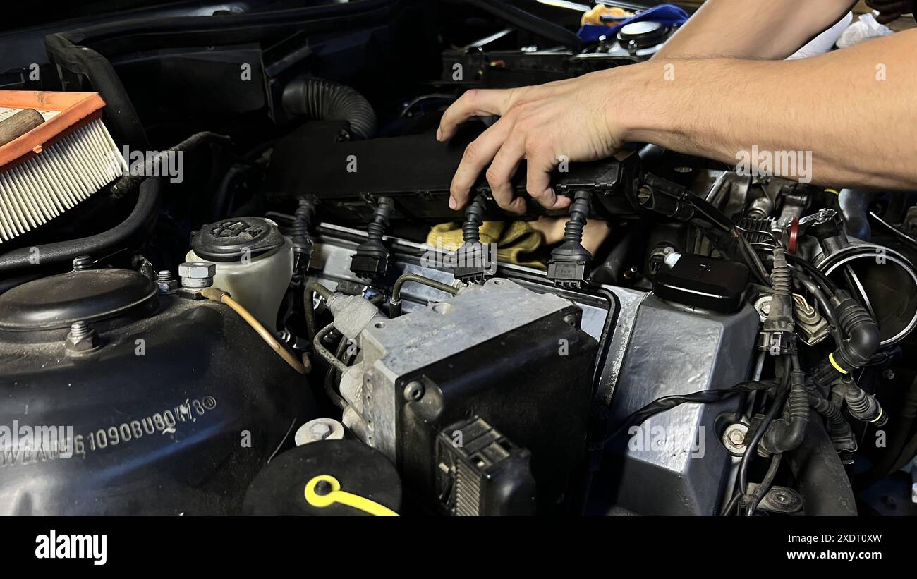 Auto mechanic working in garage. Repair service Stock Photo - Alamy