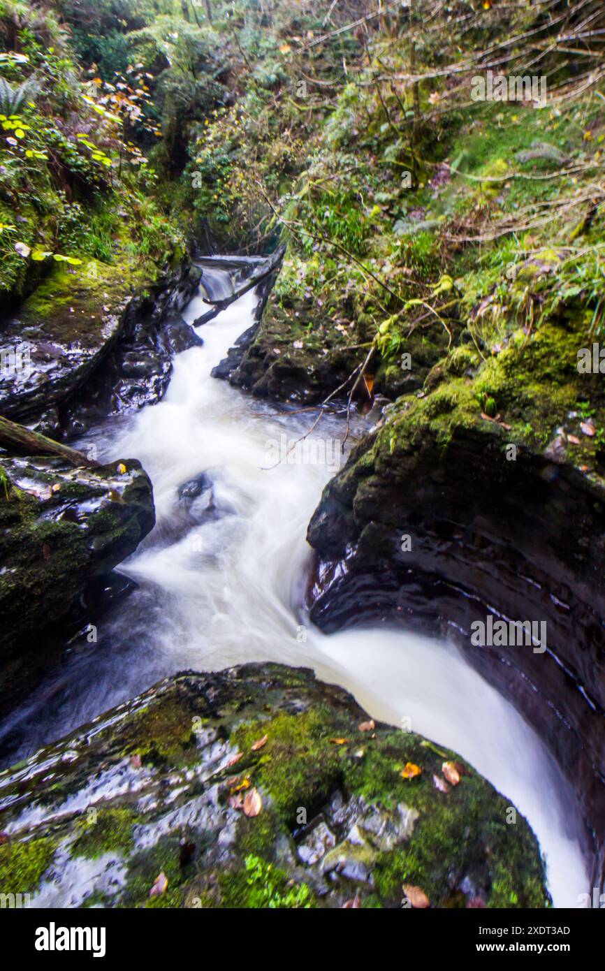 The fast flowing stream of the river Mynach flowing through a series of ...