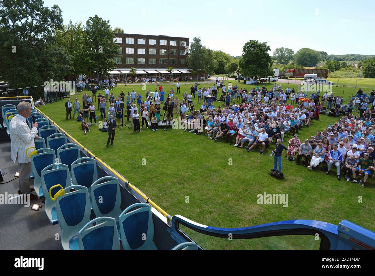 Reform UK leader Nigel Farage speaking on top of a double decker bus at ...