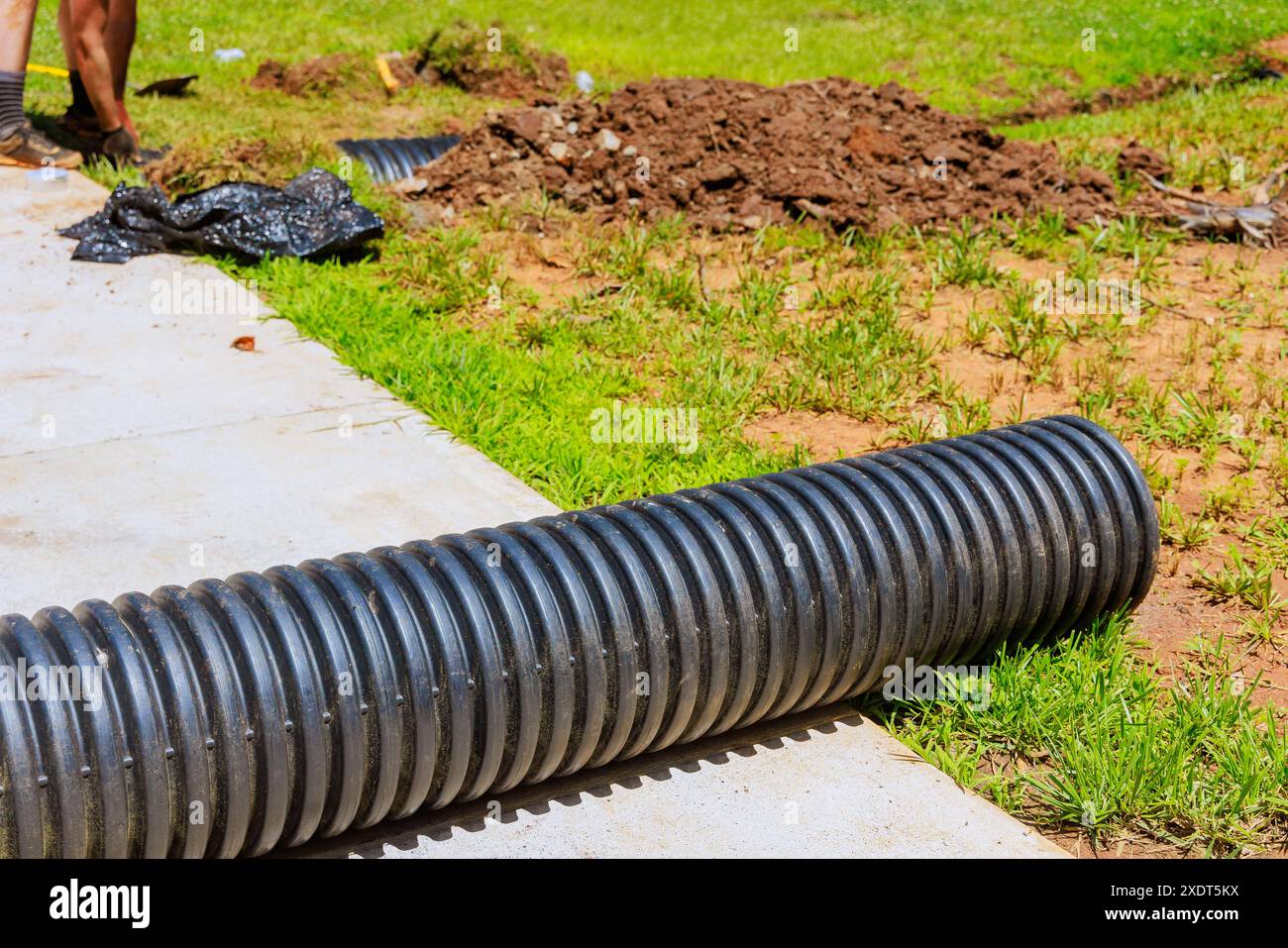 Installation of plastic black pipes for flow of rainwater to main ...