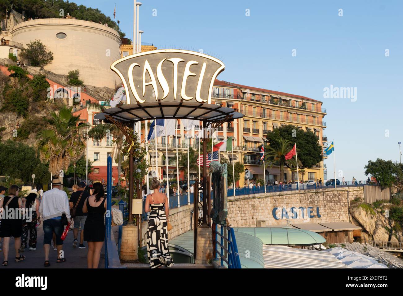 Castel beach with sign, sea wall and tourists. Nice, Alpes-Maritimes ...