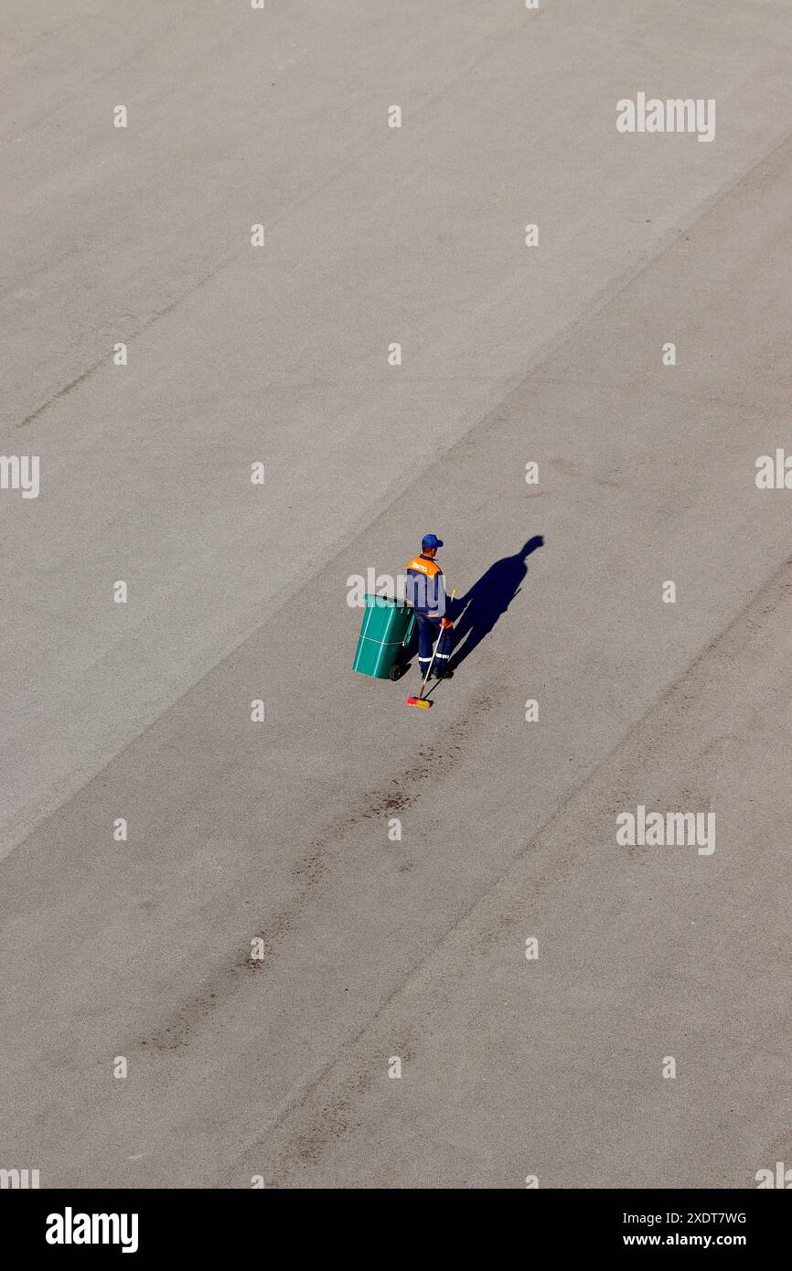 A solitary lone dockside worker finishes his shift and walks away with ...