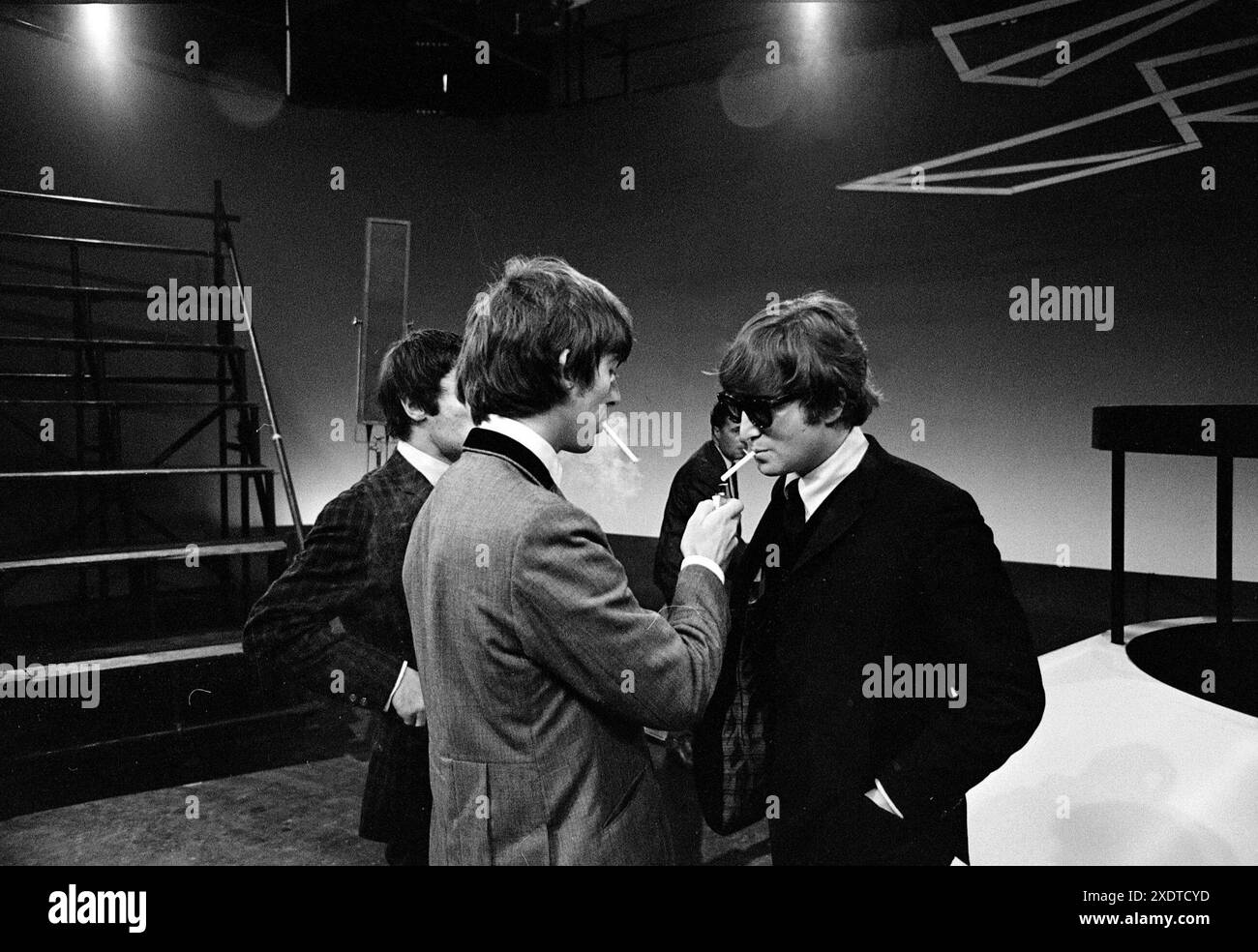 George Harrison, John Lennon smoking - The Beatles in a tv studio in ...