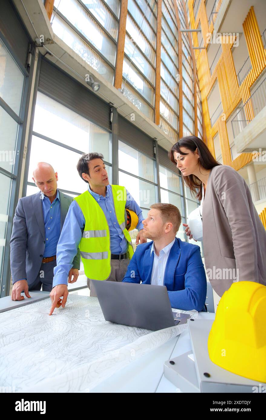 Engineers looking at map Stock Photo - Alamy