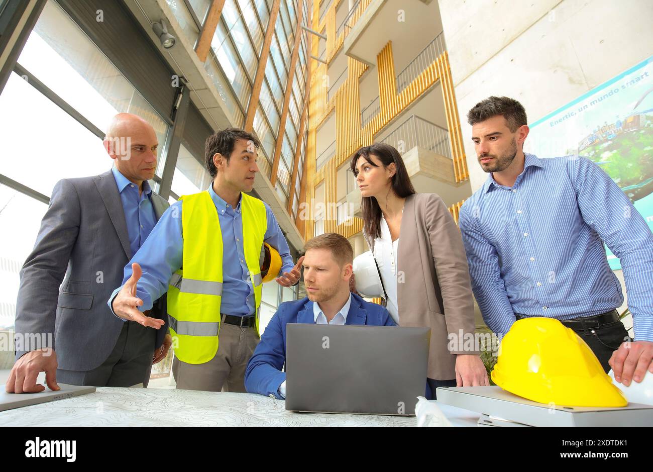 Engineers looking at map Stock Photo - Alamy