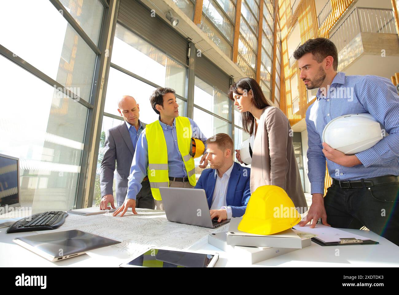 Engineers looking at map Stock Photo - Alamy