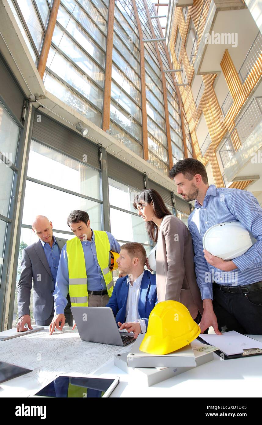 Engineers looking at map Stock Photo - Alamy
