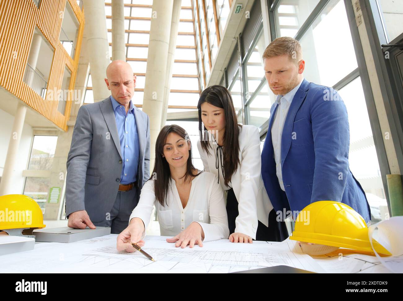 Architects looking at blueprints Stock Photo - Alamy