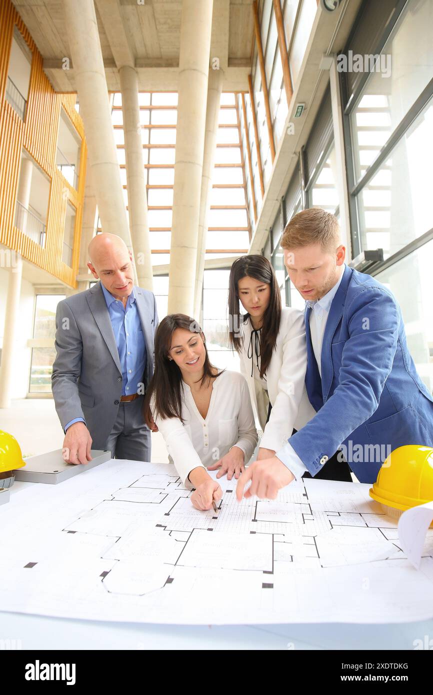 Architects looking at blueprints Stock Photo - Alamy