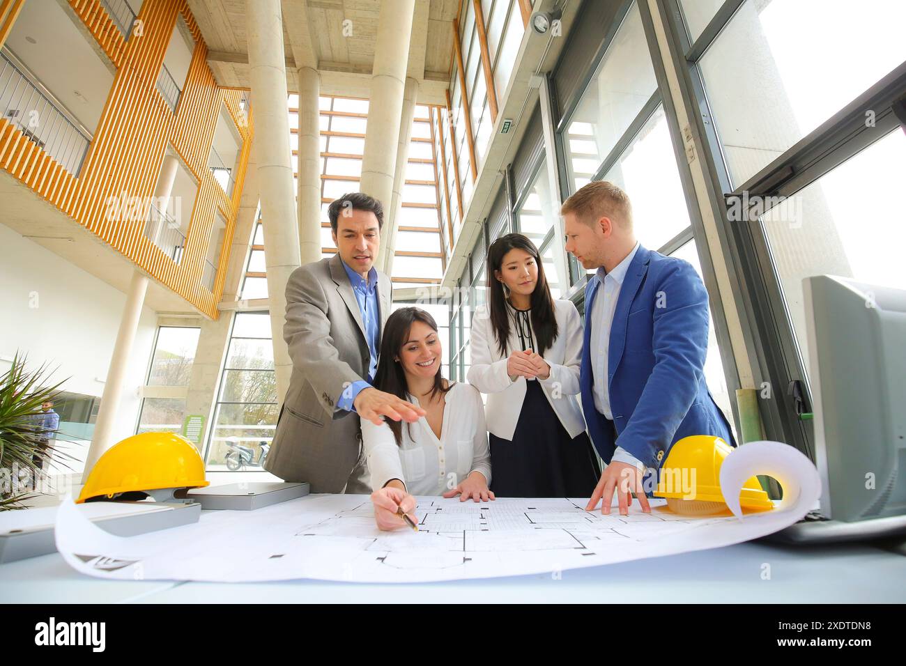 Architects looking at blueprints Stock Photo - Alamy