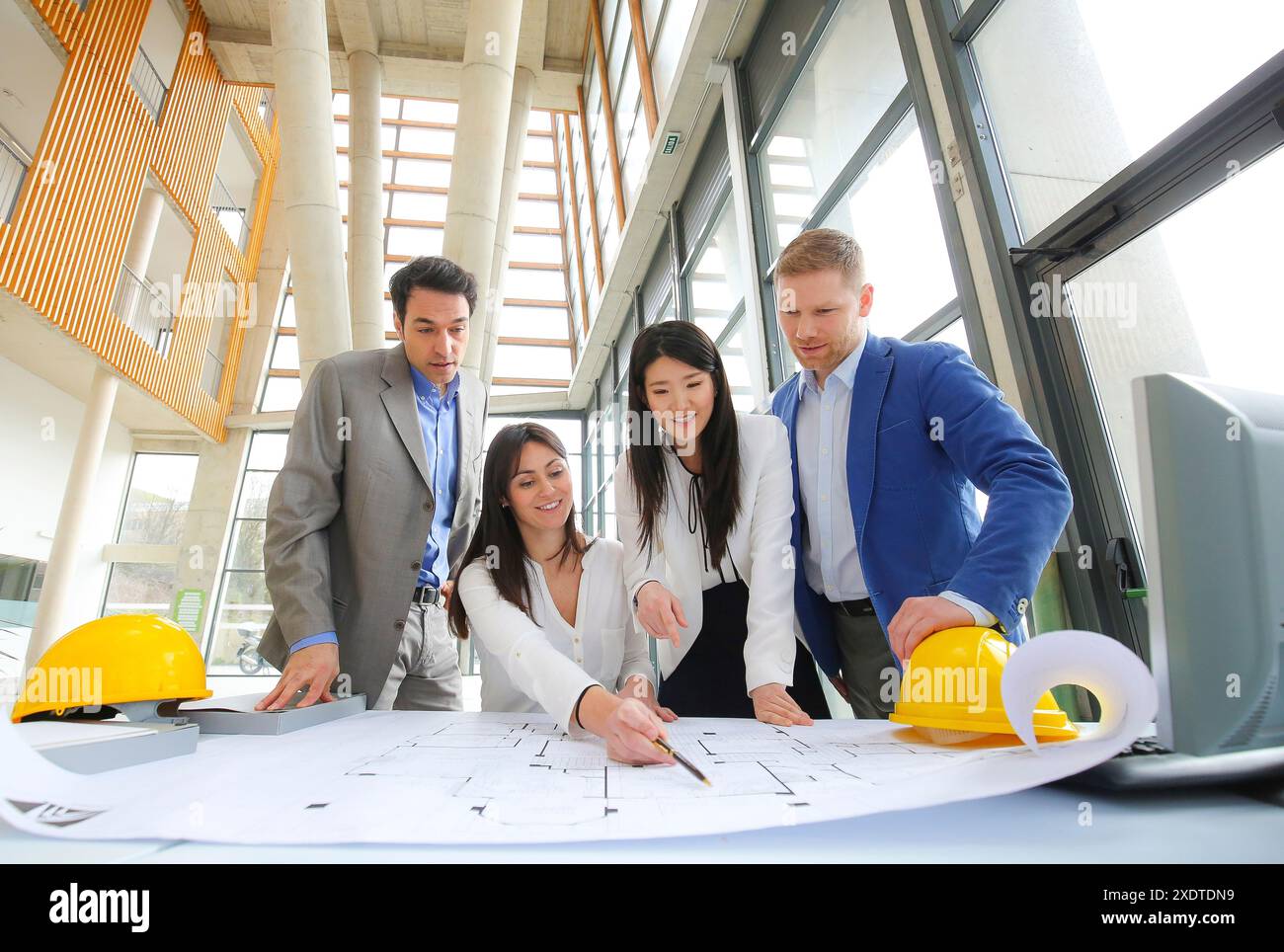 Architects looking at blueprints Stock Photo - Alamy