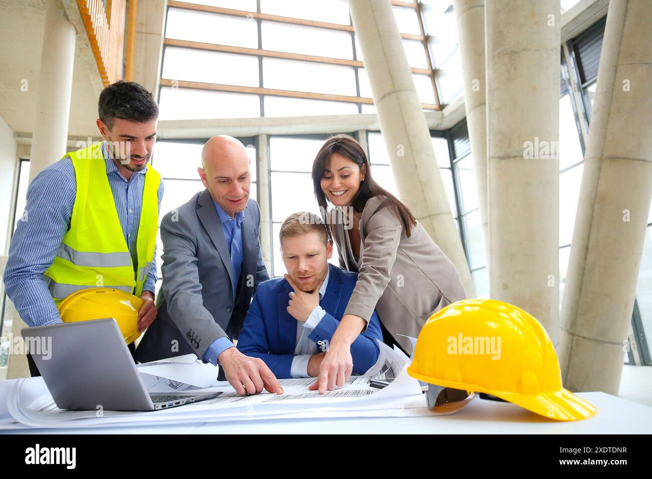Architects looking at blueprints Stock Photo - Alamy