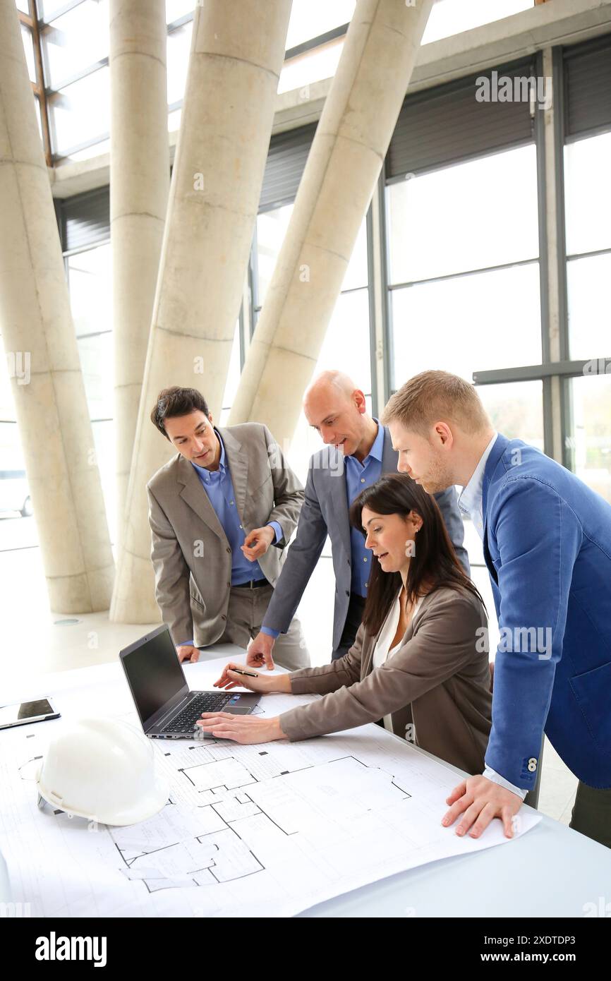 Architects looking at blueprints Stock Photo - Alamy