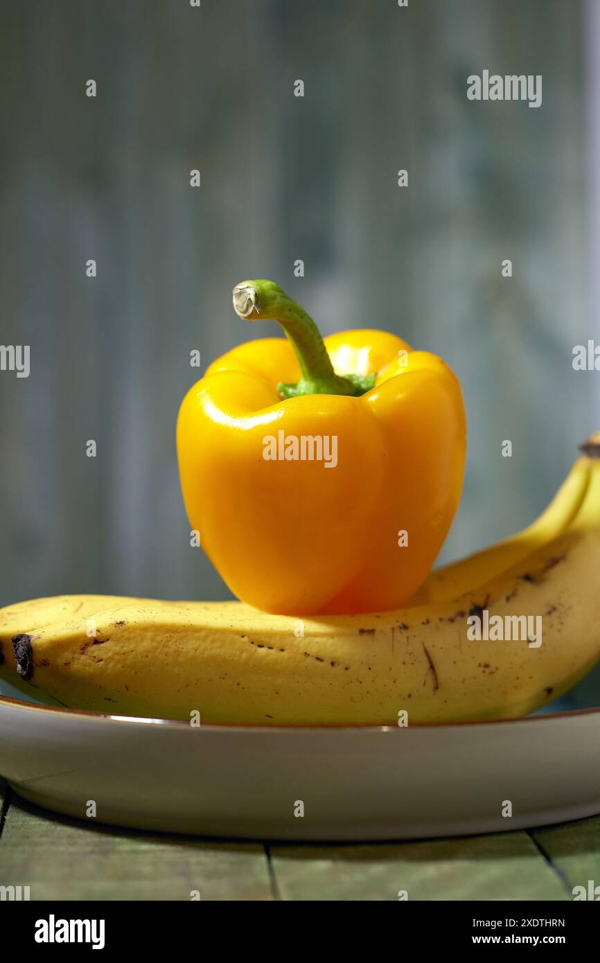 Dramatic food image with some bananas and a yellow pepper with a green ...