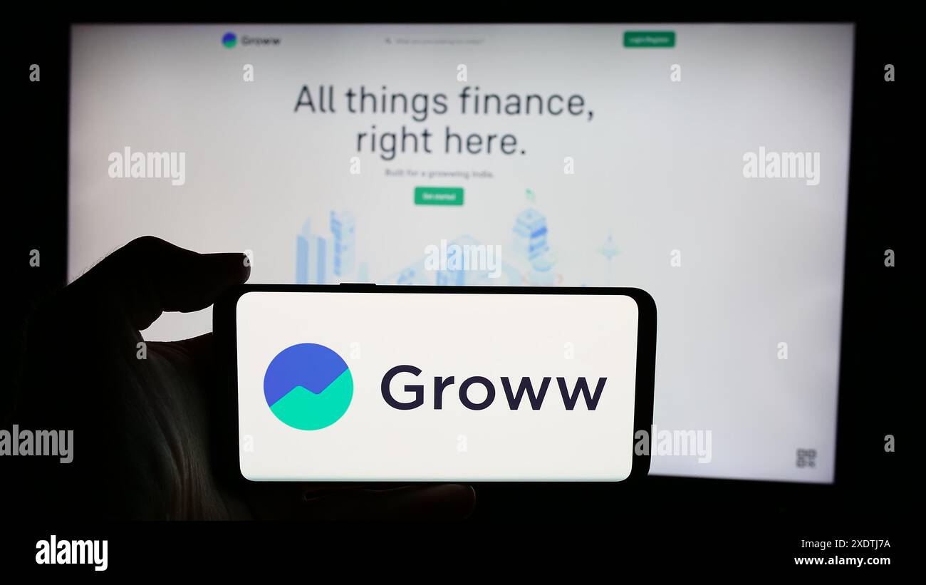 Person holding cellphone with logo of Indian fintech company Groww ...