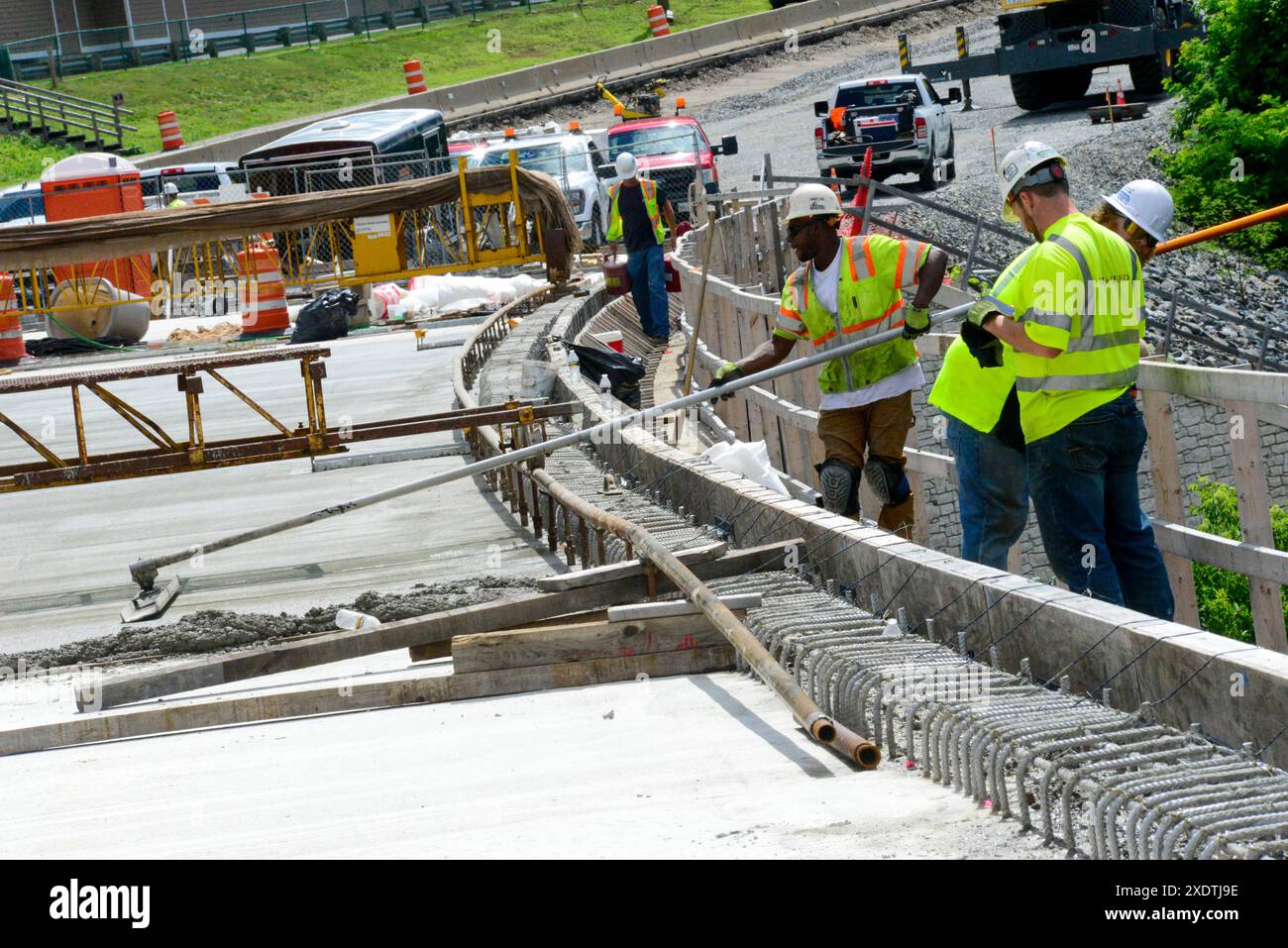 Workers smooth out the fresh concrete that was poured on the General ...