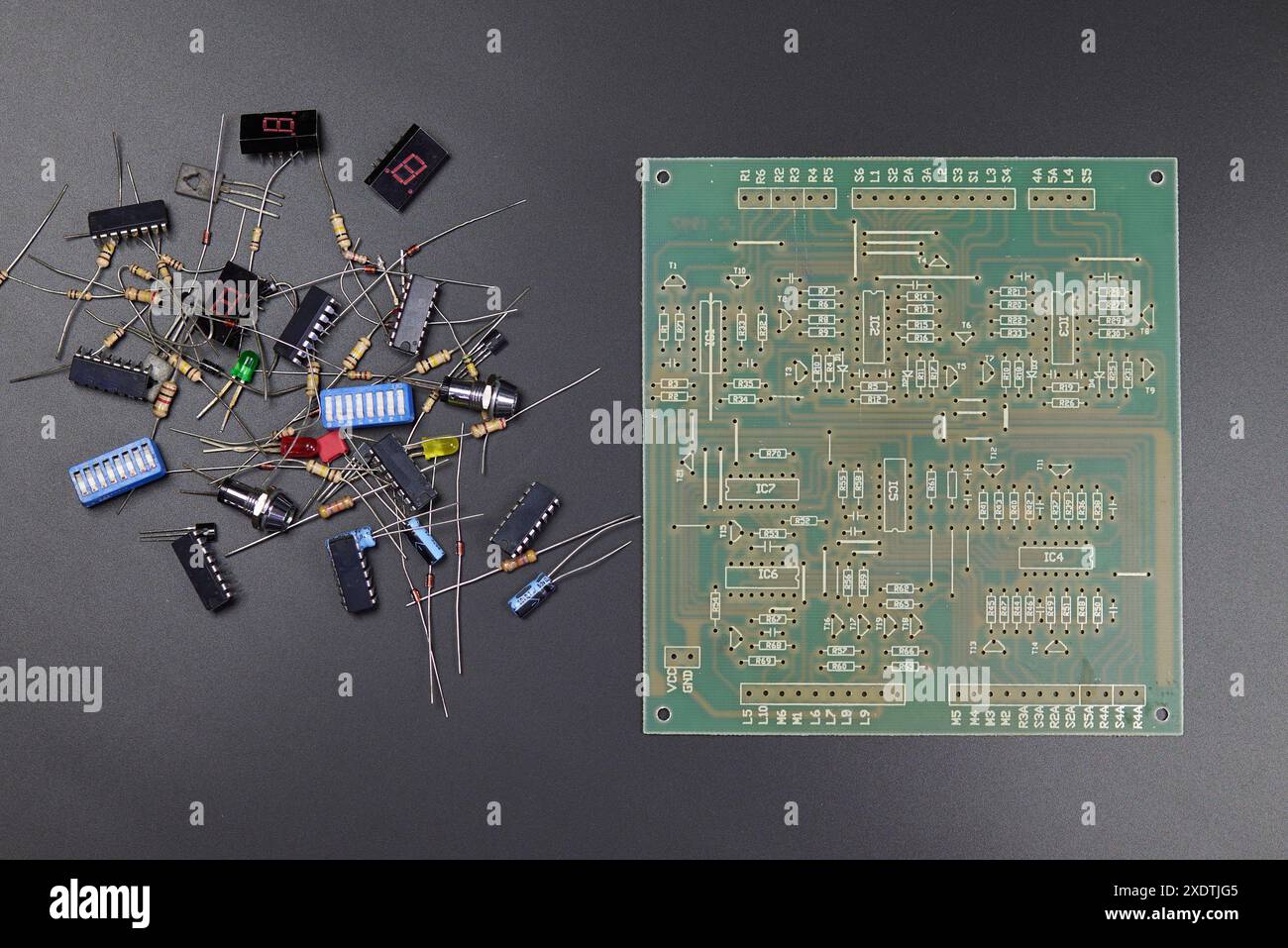Green electronic circuit board with semiconductors on black background ...