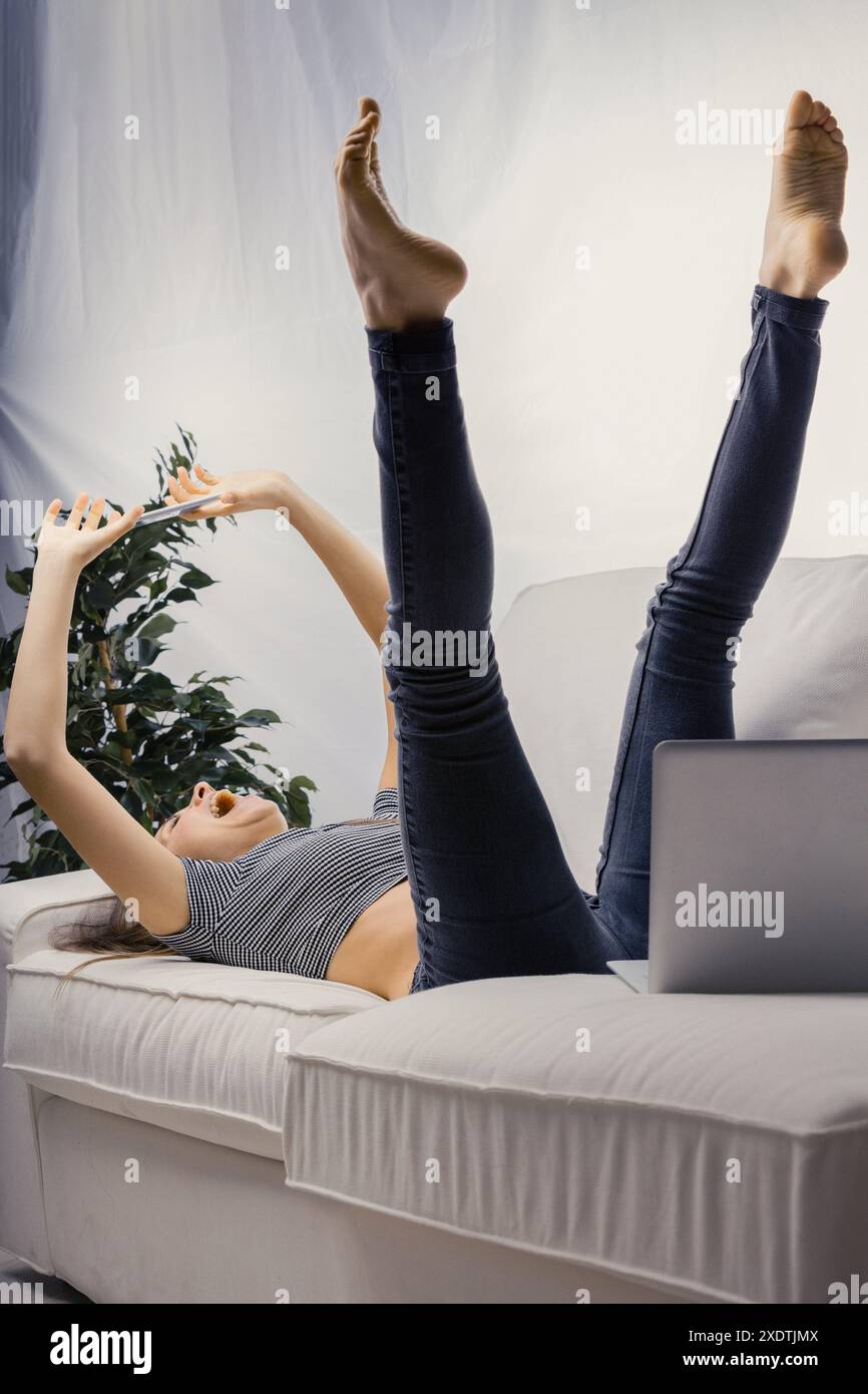 Woman lying on back legs up hi-res stock photography and images - Alamy