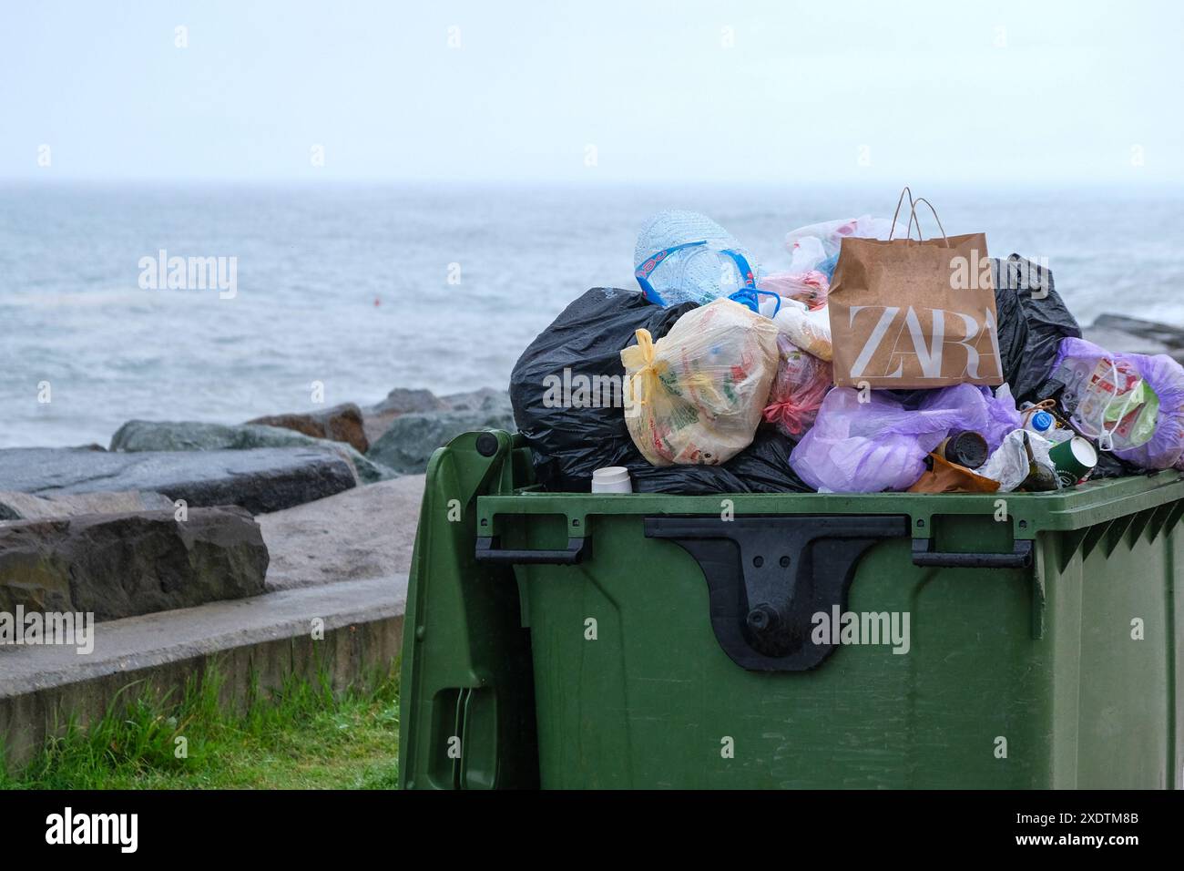 Full dumpsters garbage containers standing ear sea. Environmental ...
