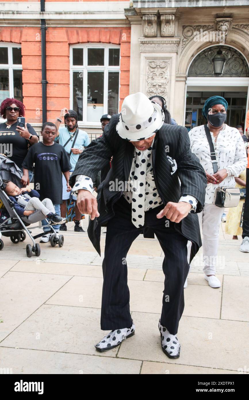 London UK 23 June 2024 A Man dances in Windrush Square as people mark ...