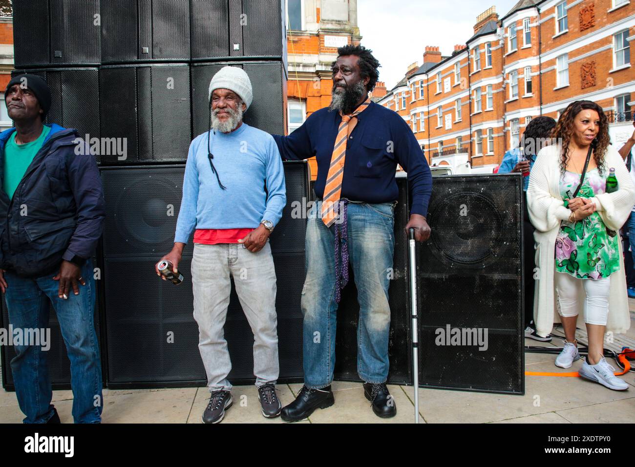 London UK 23 June 2024 People stand next to loud speakers in Windrush ...
