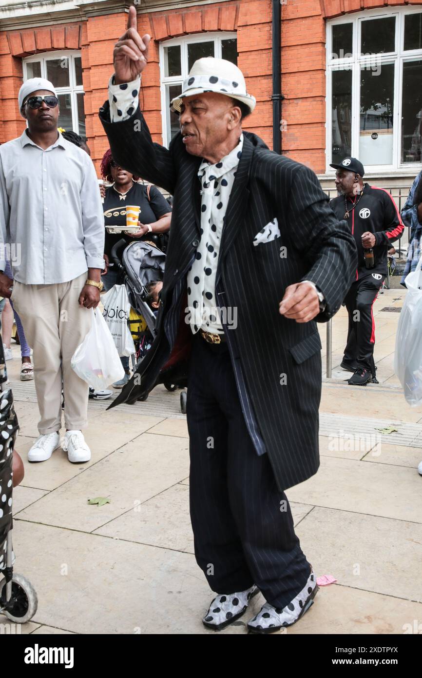 London UK 23 June 2024 A Man dances in Windrush Square as people mark ...