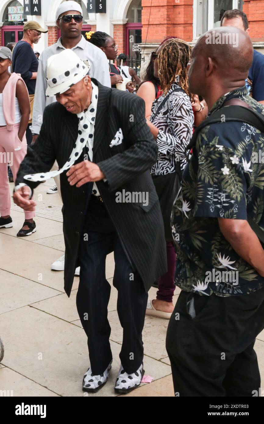 London UK 23 June 2024 A Man dances in Windrush Square as people mark ...