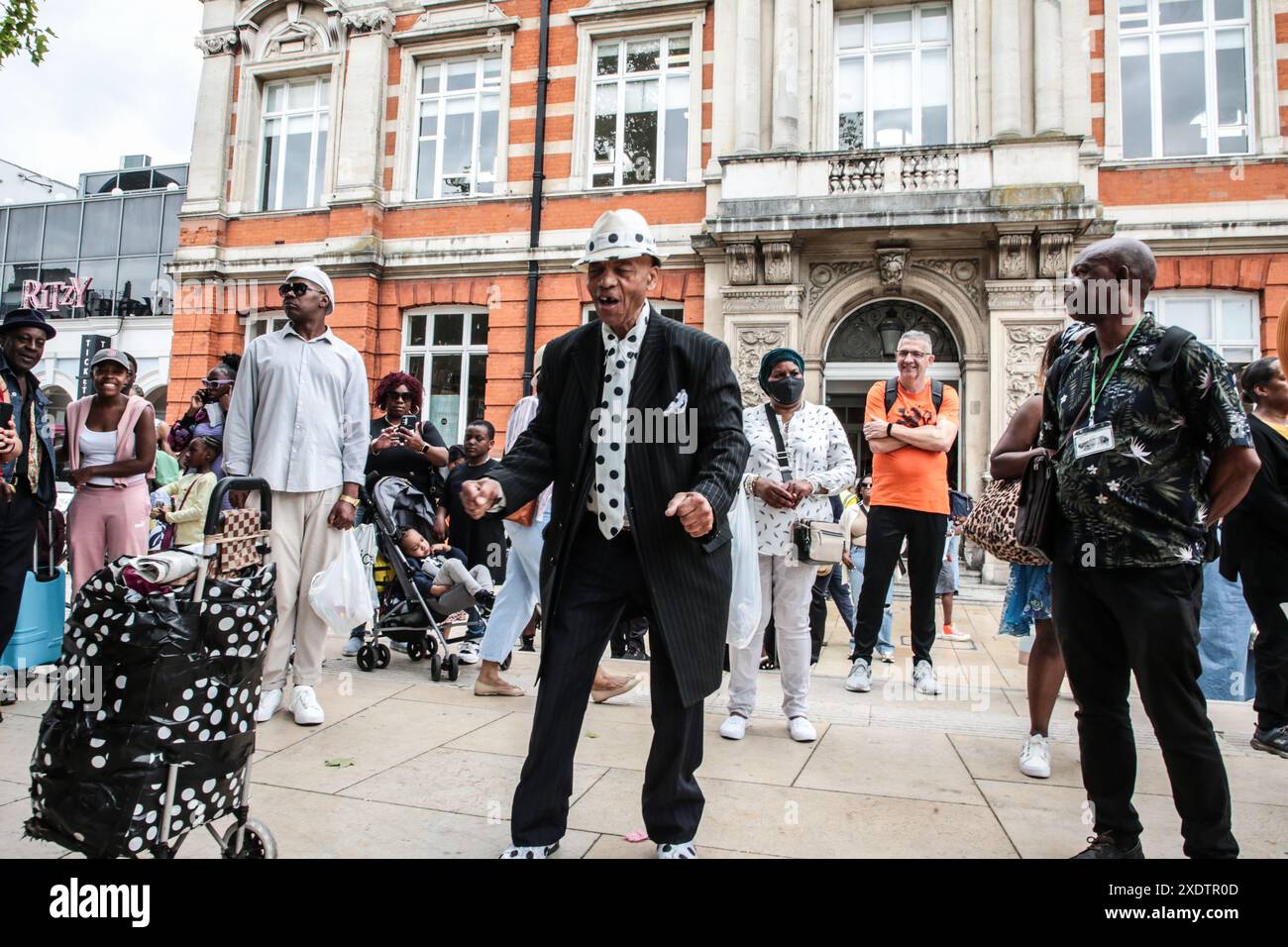 London UK 23 June 2024 A Man dances in Windrush Square as people mark ...