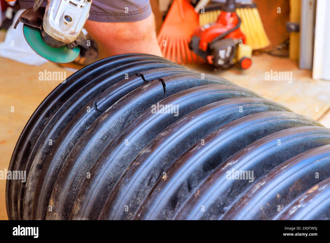 For purpose of connecting another pipe, hole was cut in black plastic ...