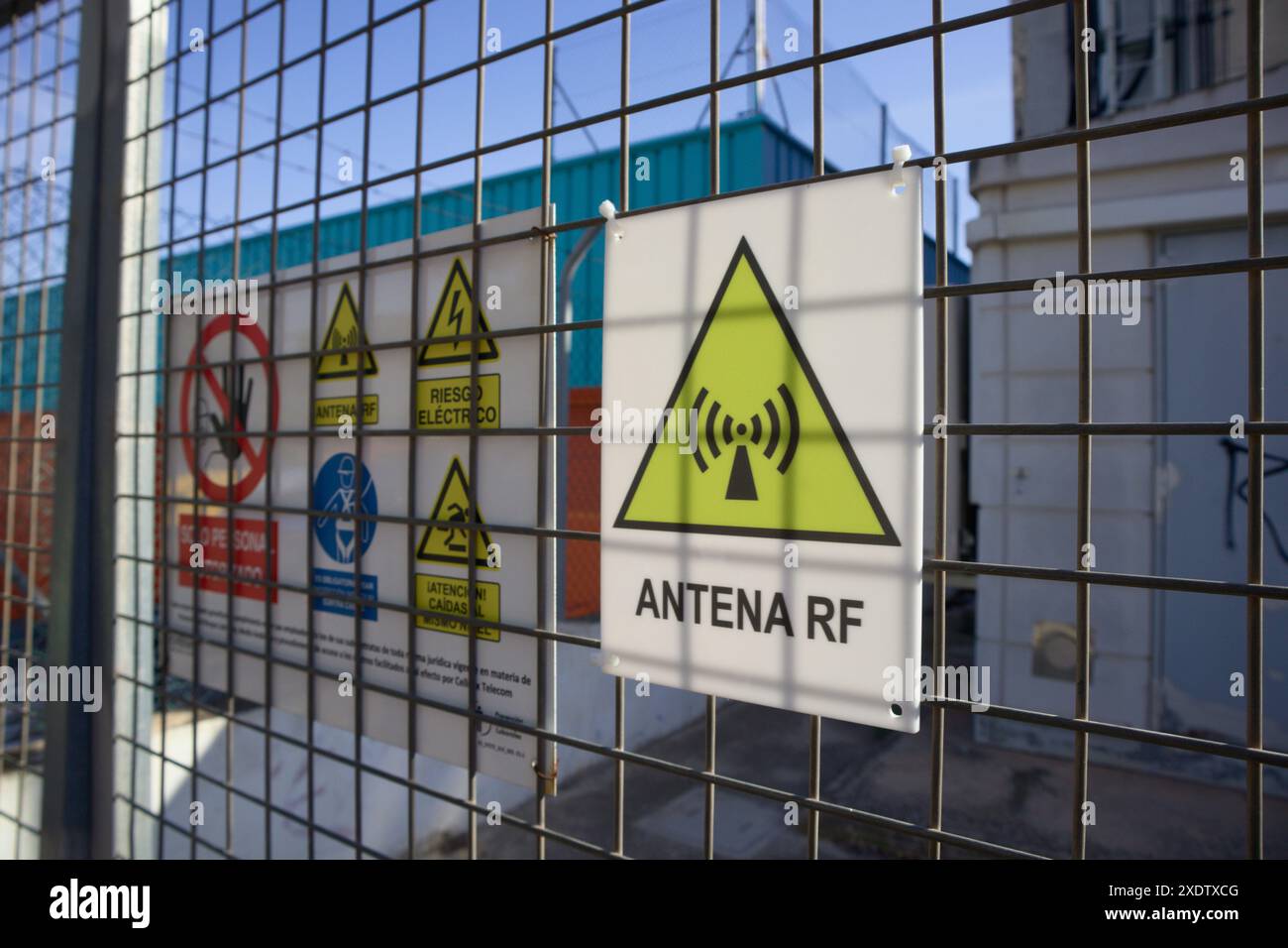 Image of a fence full of signs warning of danger due to the proximity ...