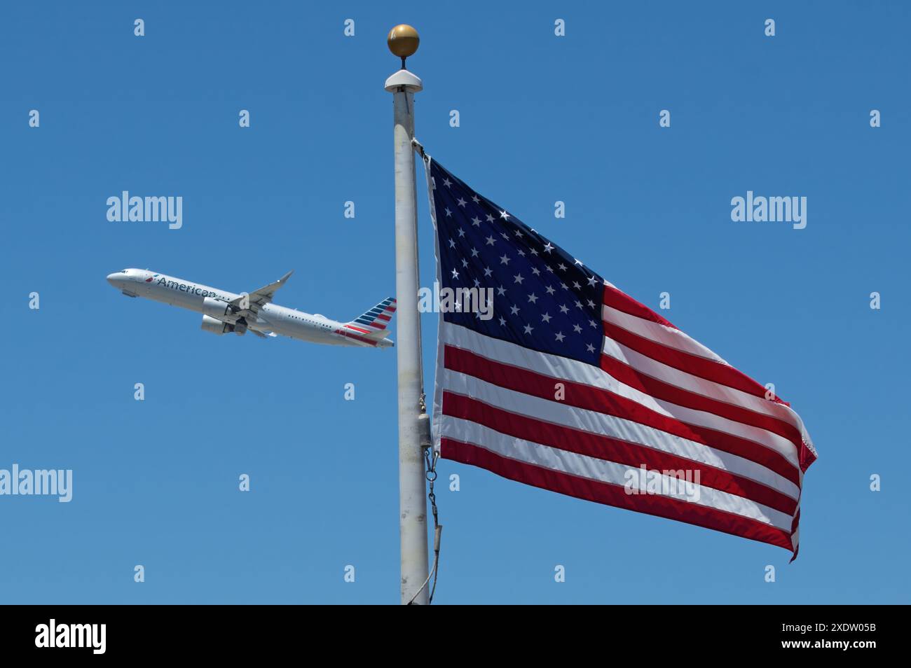 The American flag and an American Airlines jet in the distance shown ...