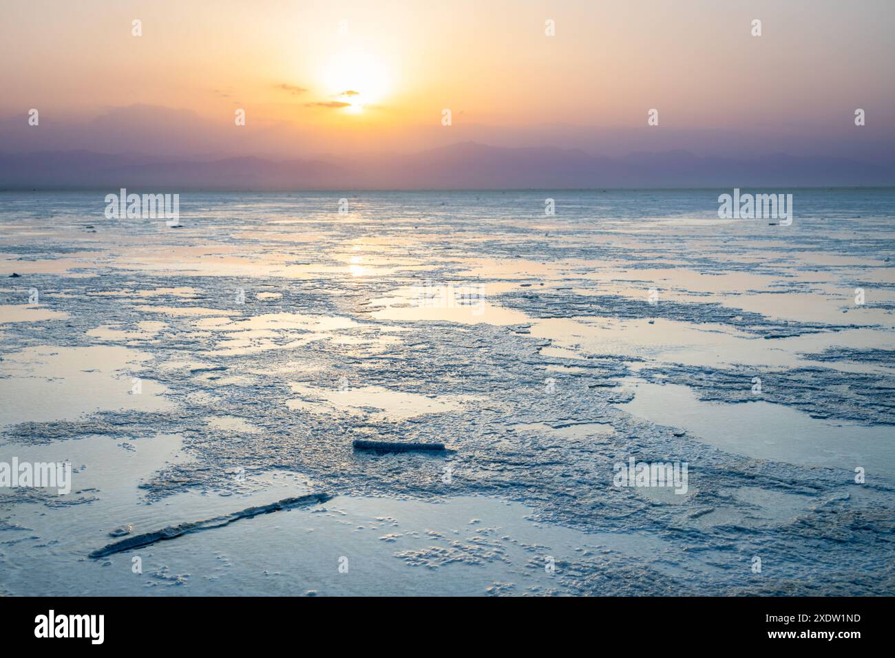 Sunset over Ethiopian Karum salt lake surface, Danakil Depression ...