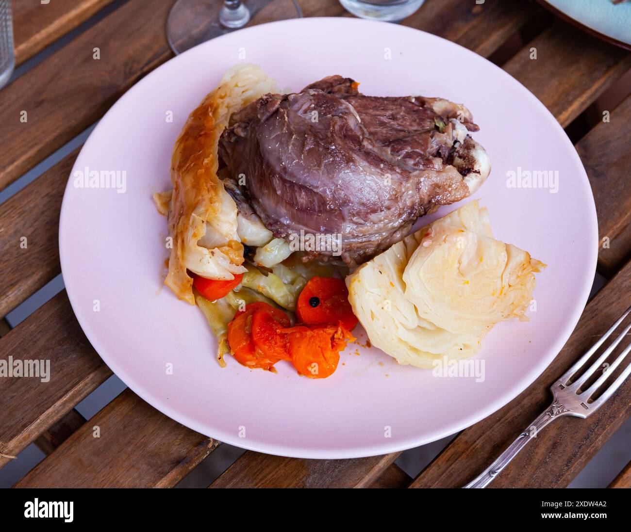 Spanish traditional dish - pork cheeks with cabbage Stock Photo - Alamy