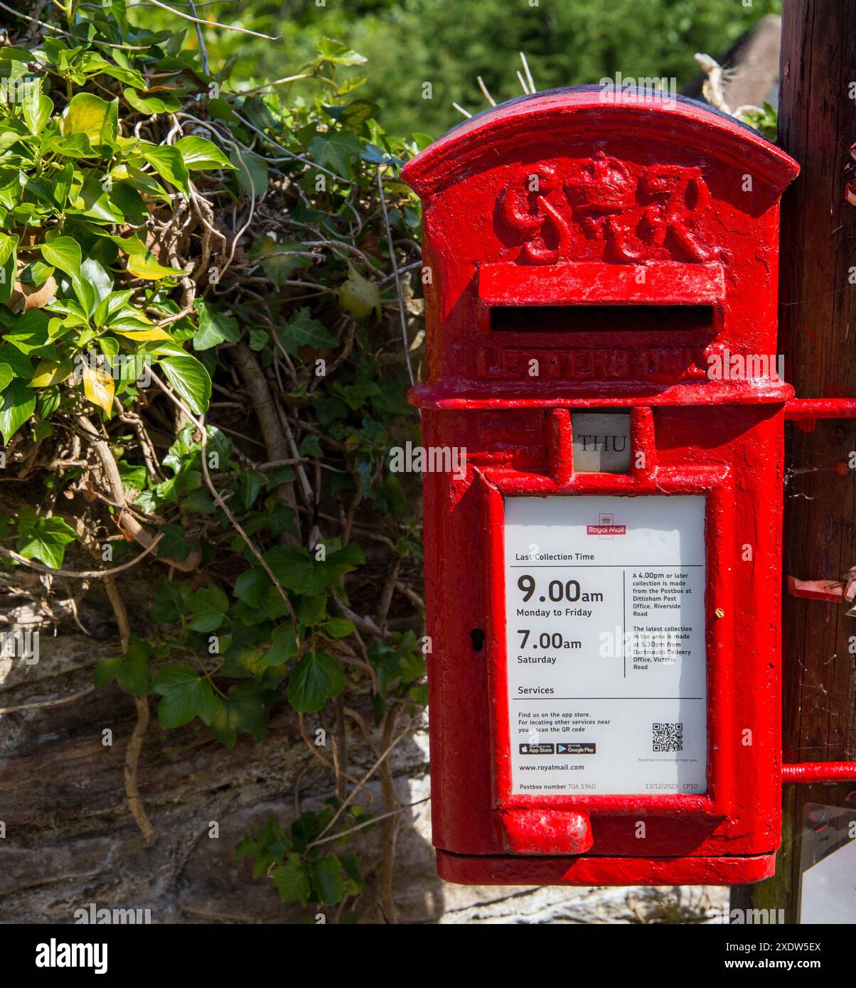 Traditional red British Royal Mail G R postbox with collection times ...