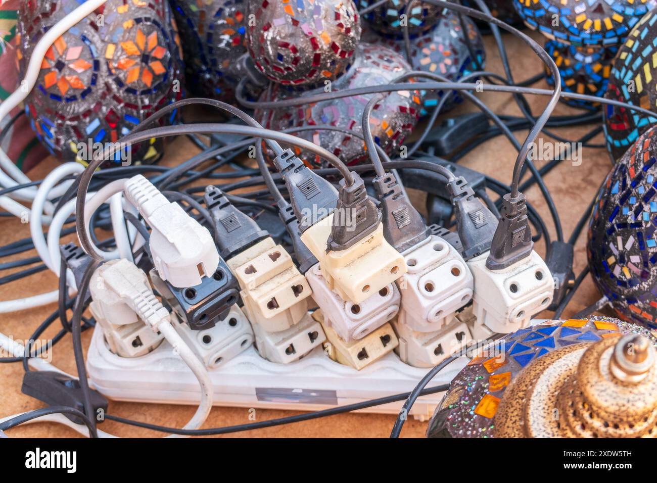 Old and damaged electric adapter power plug has many appliances are ...