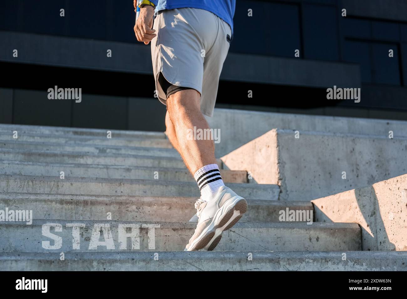 Sporty man running upstairs outdoors. Concept of start Stock Photo - Alamy