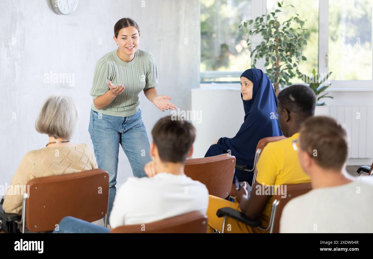Young girl giving lecture to group during educational class Stock Photo ...