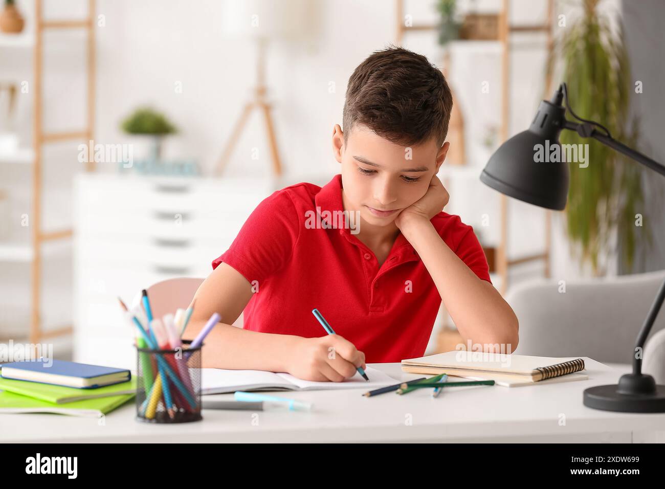 Little boy doing lessons at home Stock Photo - Alamy